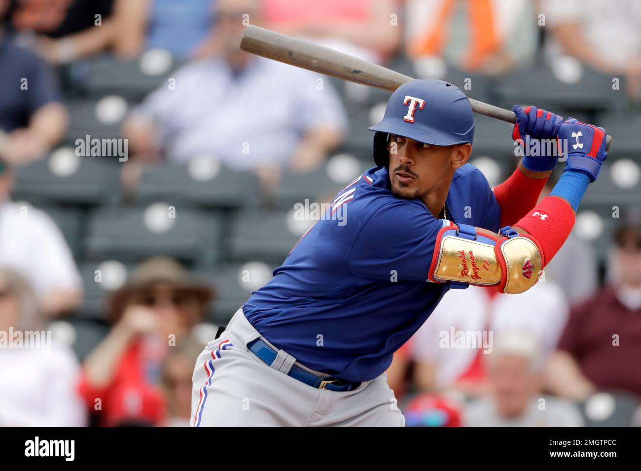 Texas Rangers' Ronald Guzman bats during the second inning of a spring ...