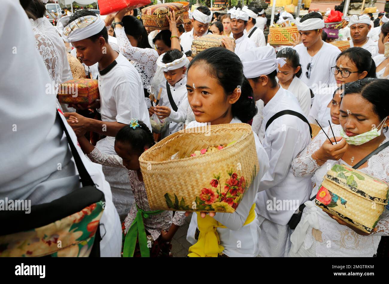 Balinese people carry their offering to celebrate the Kuningan festival ...