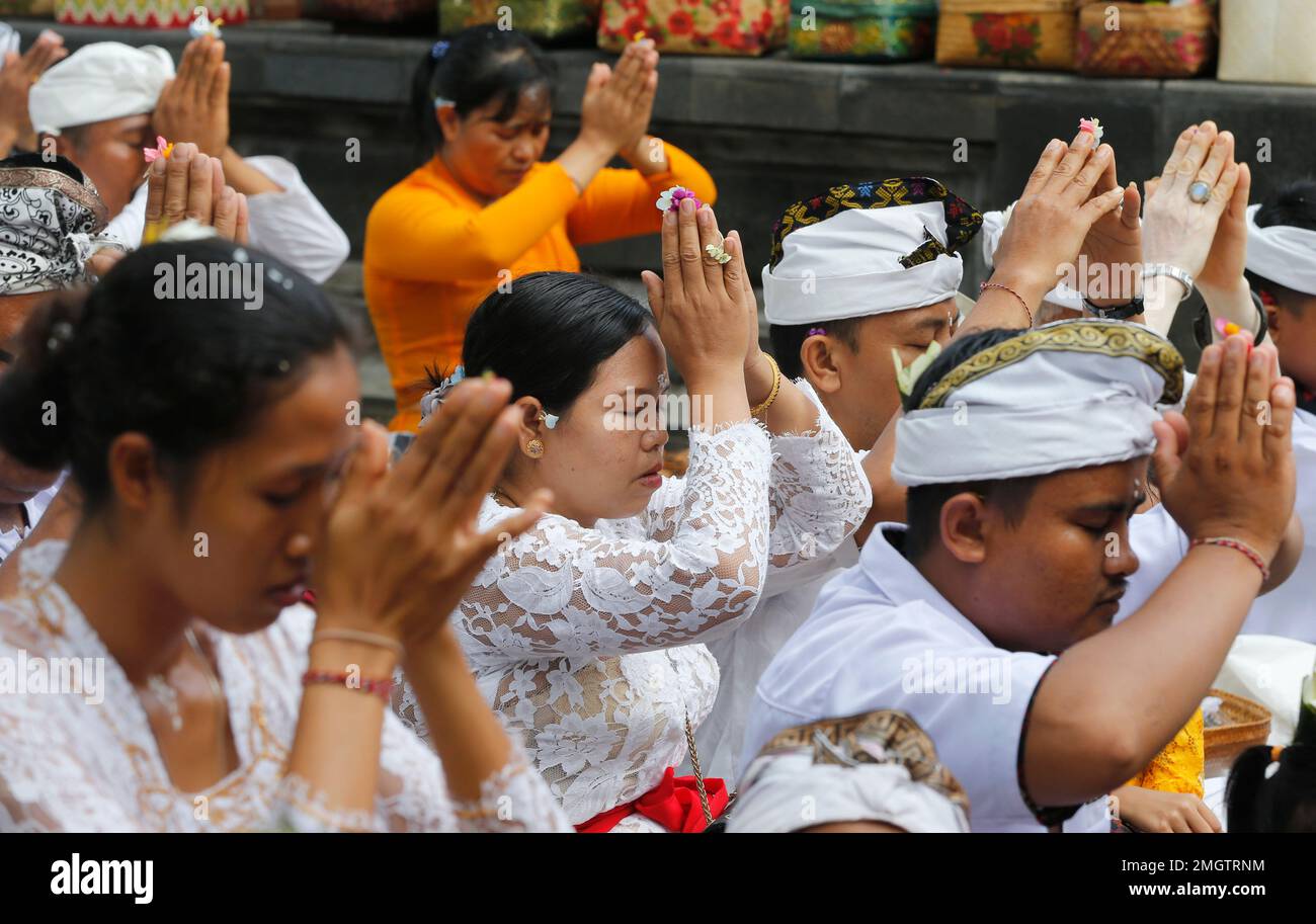 Balinese people pray to celebrate the Kuningan festival at a Hindu ...
