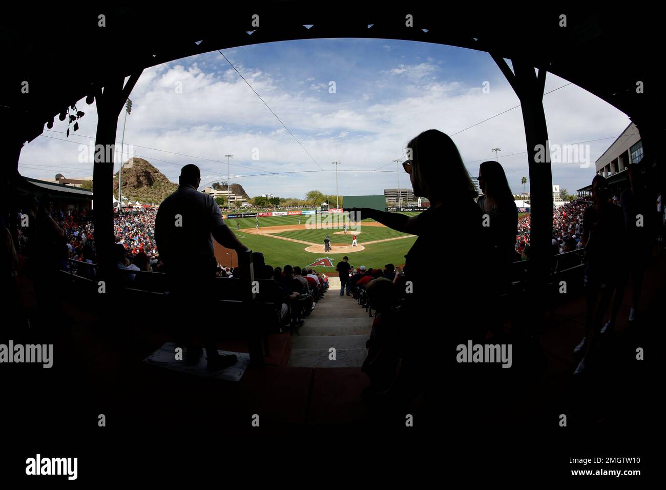 Fans watch from the concourse during the sixth inning of a spring ...