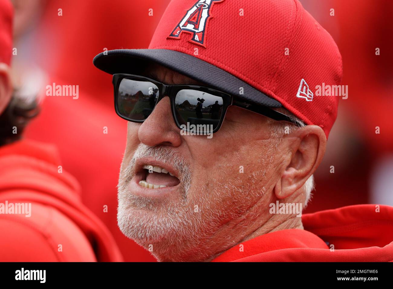 Los Angeles Angels manager Joe Maddon talks to a player before a spring ...