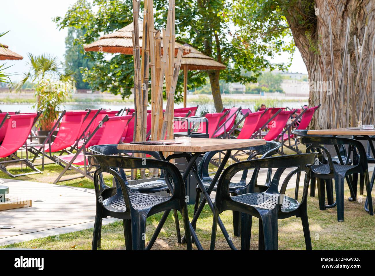 shadow cafe table and chairs on the terrace outside in riverside bar ...