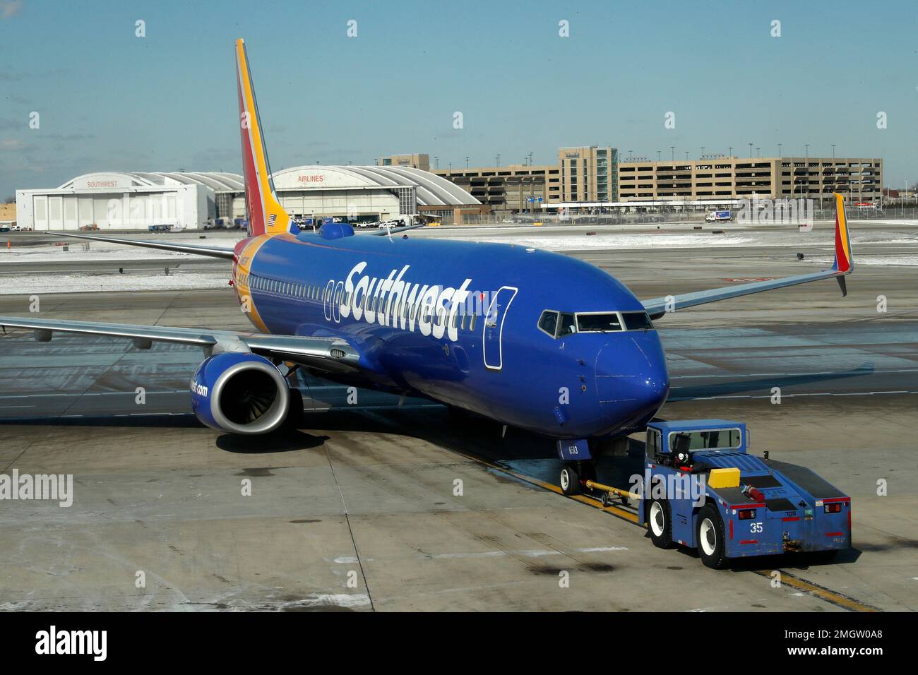 A Southwest Airlines flight is pushed away from a gate at Midway ...