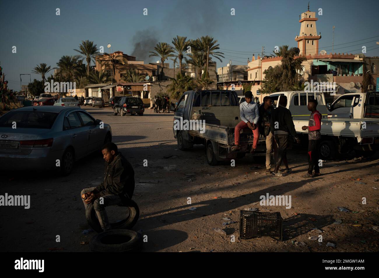 Migrants from Niger looking for jobs wait at a crossroad in the ...