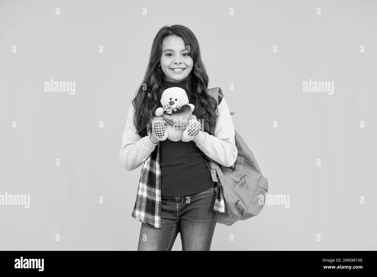 cheerful child with toy bear. teen girl carry backpack. back to school ...