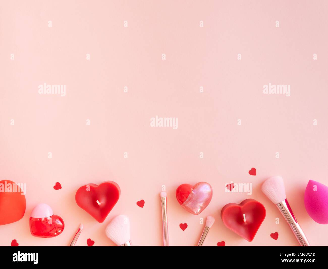Pink valentines day background with different hearts, cosmetics brushes ...