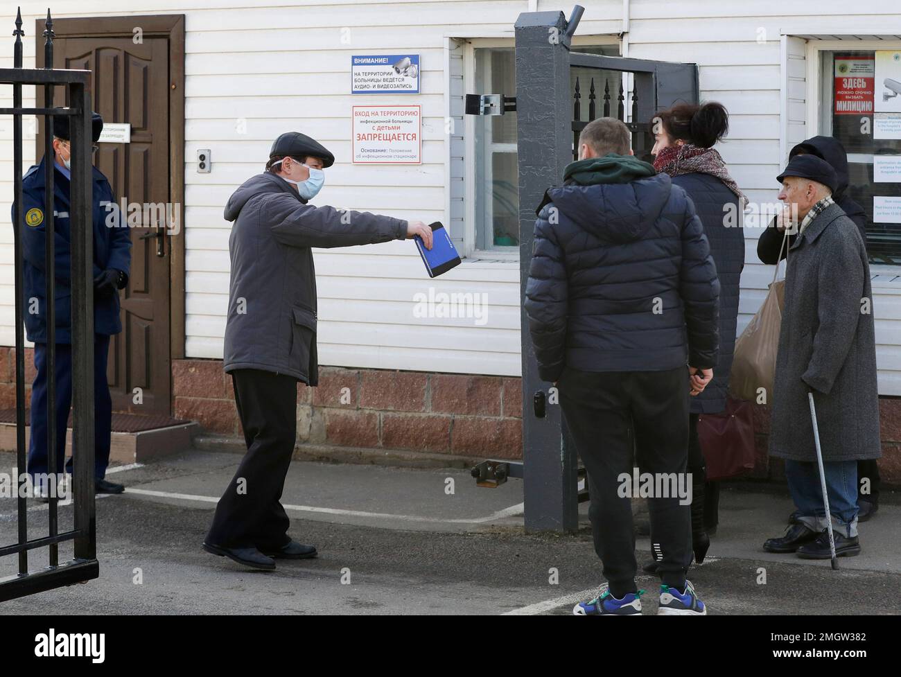 A security guard forbids access for visitors to the hospital for ...