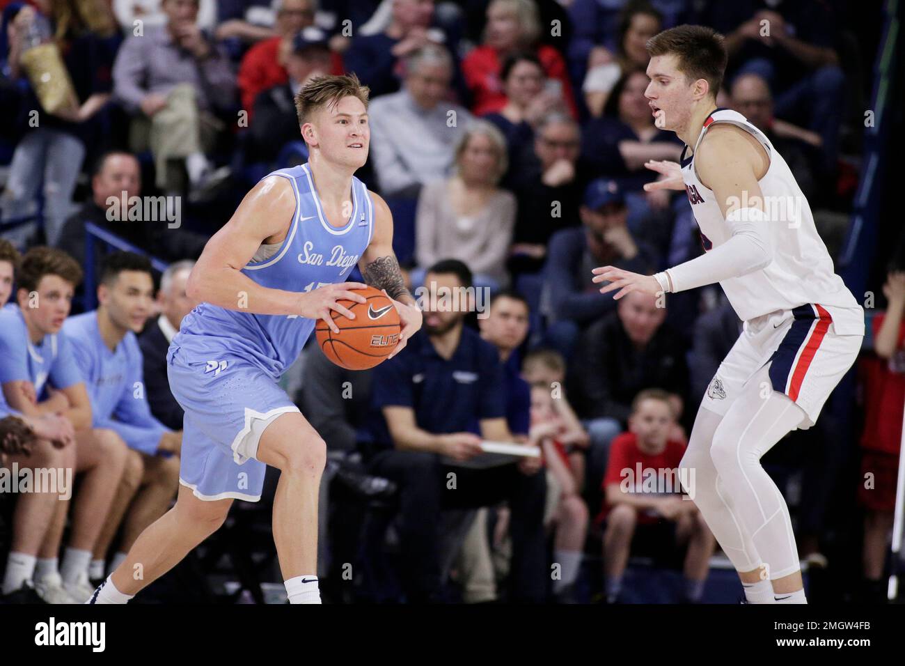 San Diego forward Alex Floresca, left, looks to pass while defended by ...