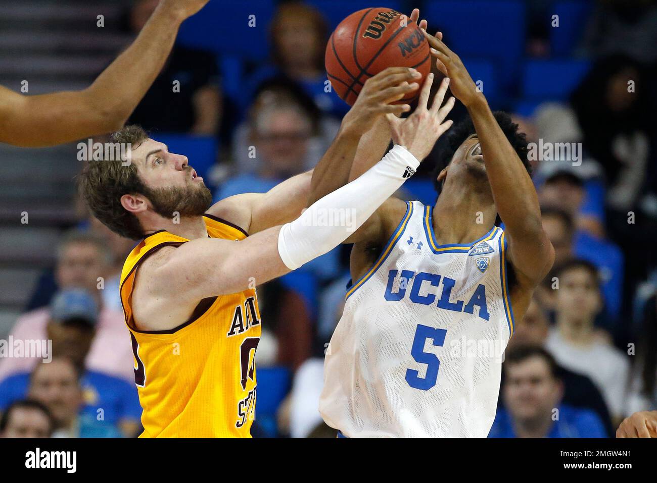 UCLA guard Chris Smith (5) and Arizona State forward Mickey Mitchell ...