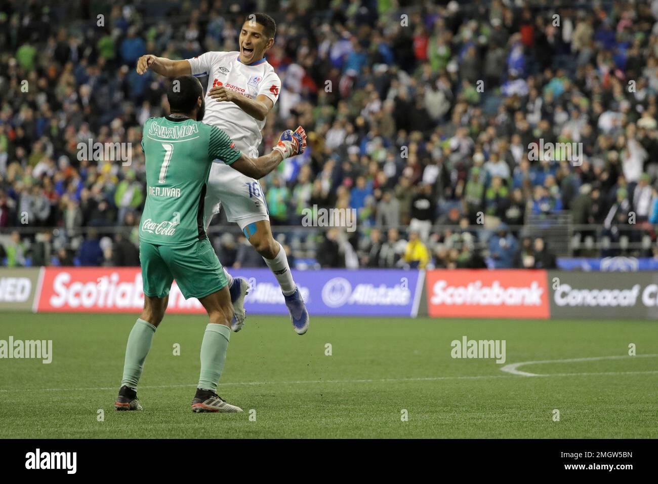 Olimpia defender Johnny Leveron, right, leaps into the arms of ...