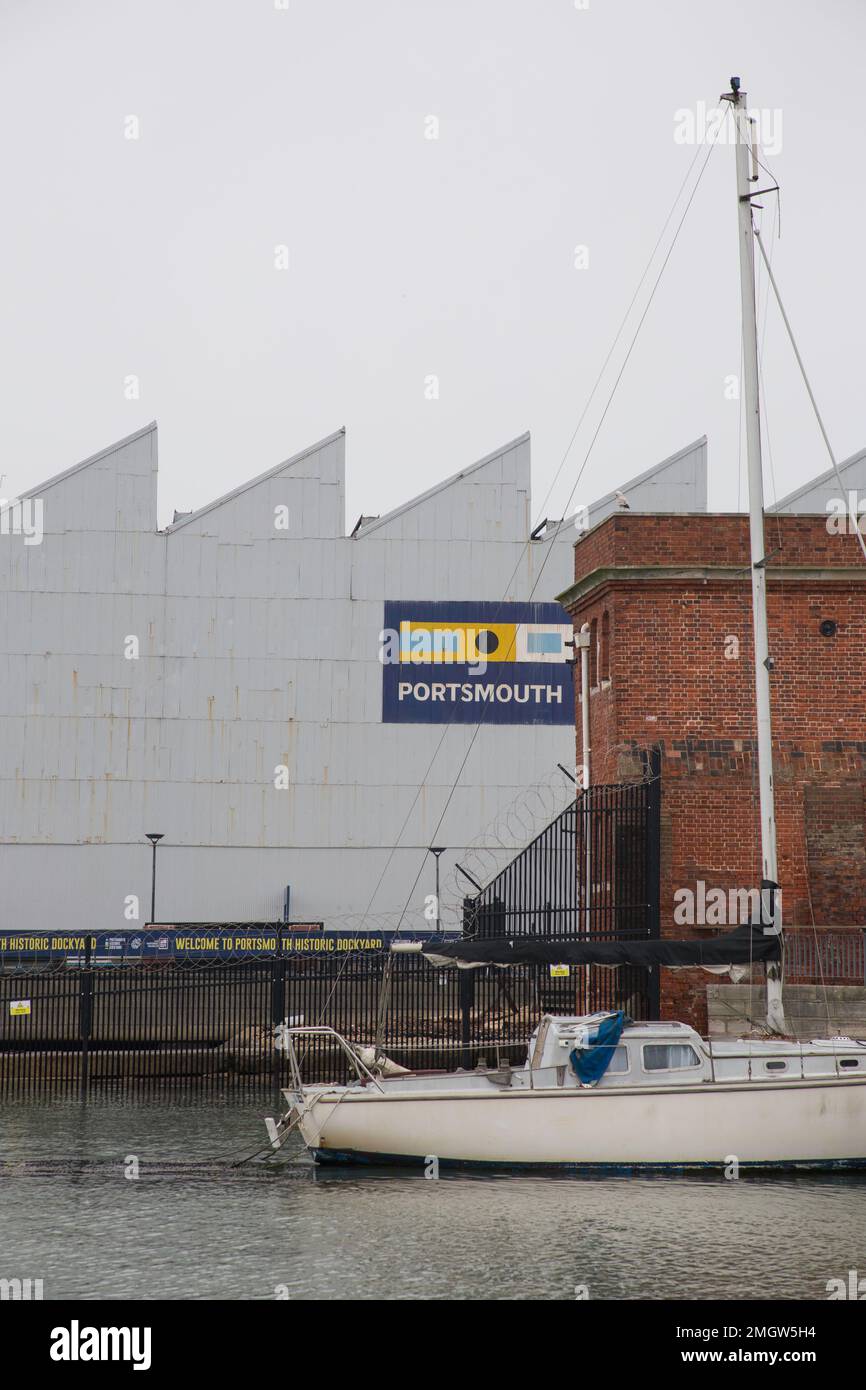 Portsmouth Dockyard sign with Spinnaker Tower and boats Stock Photo - Alamy