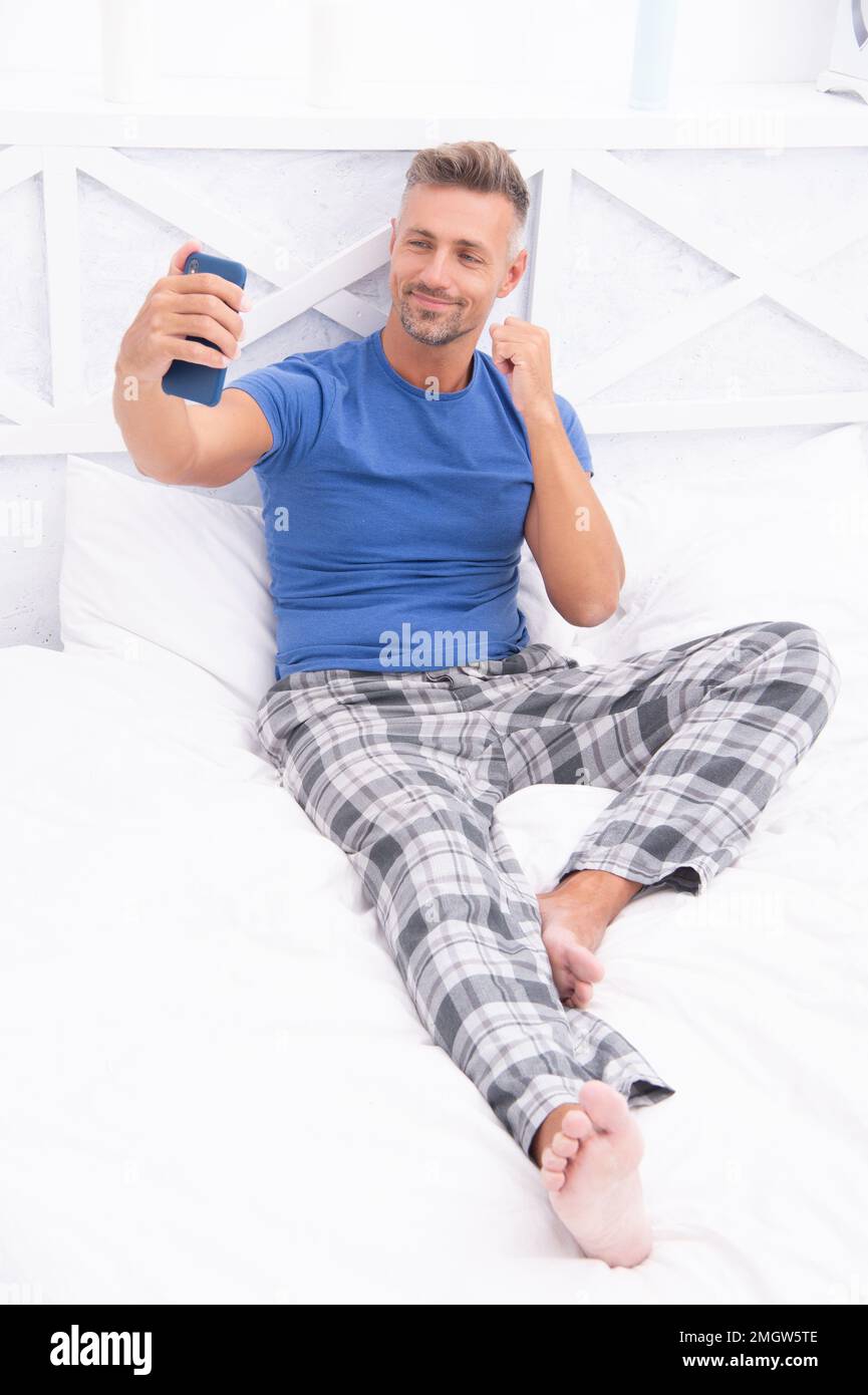 positive blogging man with phone wear pajama. blogging man with phone ...