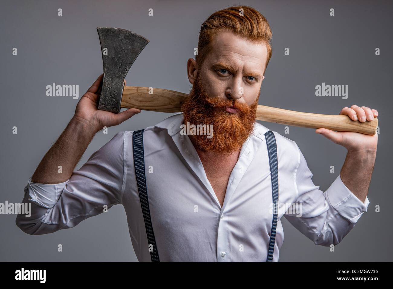 caucasian masculine man with axe in studio. masculine man with axe on ...