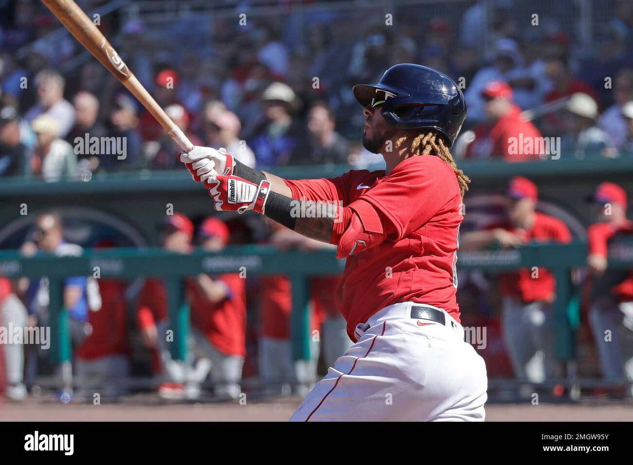 Boston Red Sox' Jonathan Arauz follows through on a three-run home run in the third inning of a ...