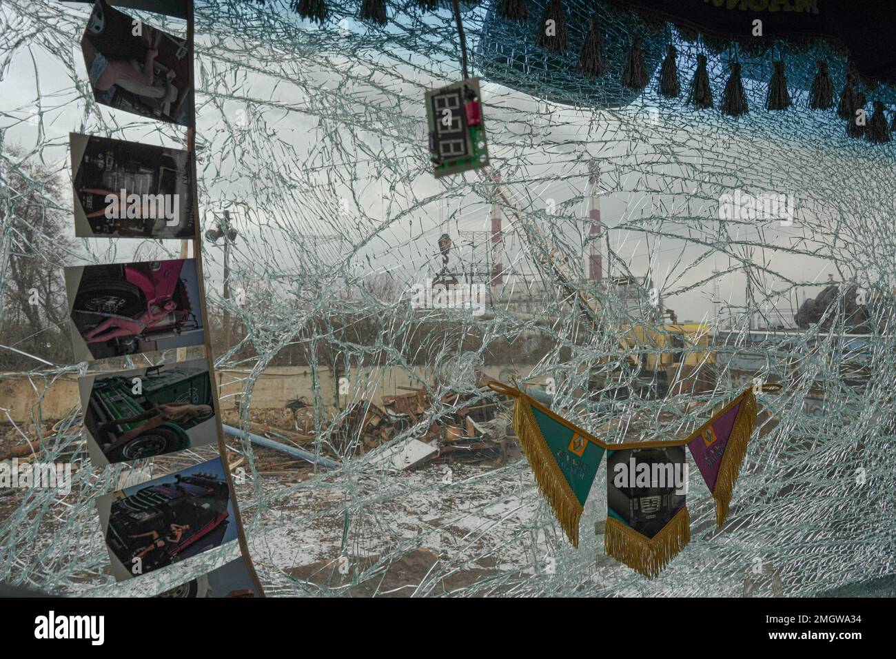 Power station are seen through a smashed window of a damaged truck ...