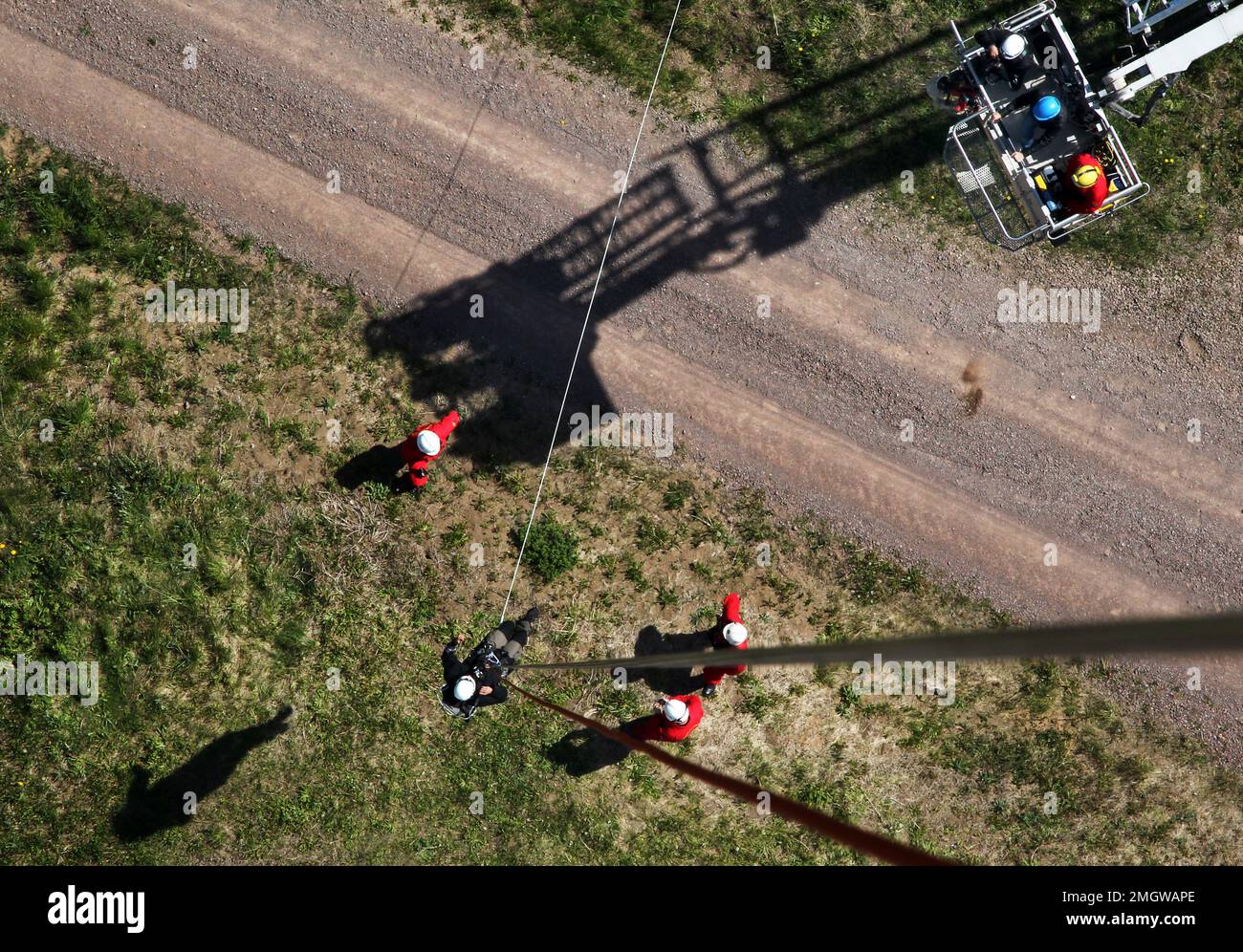 Fire-fighters practicing rescuing a person, after a fictitious accident ...