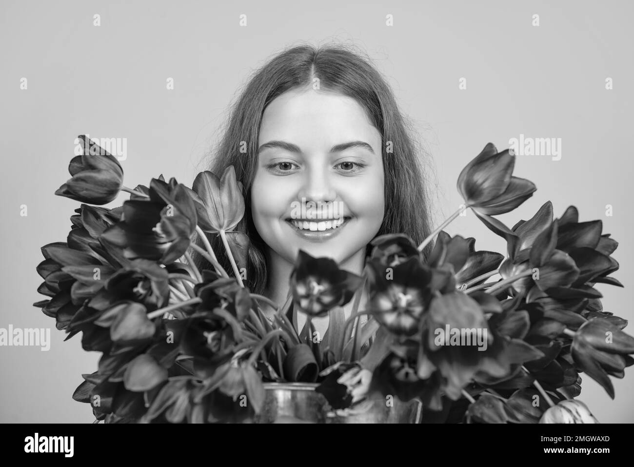 happy teen girl hold spring tulip flowers on yellow background Stock ...