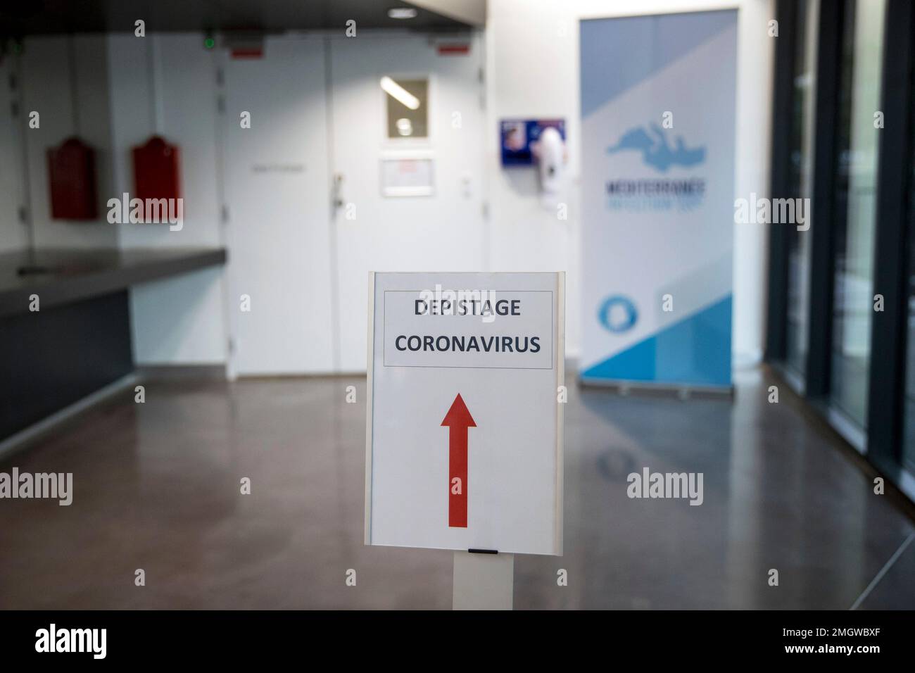 A sign reading "Coronavirus screening" indicates the way to the ...