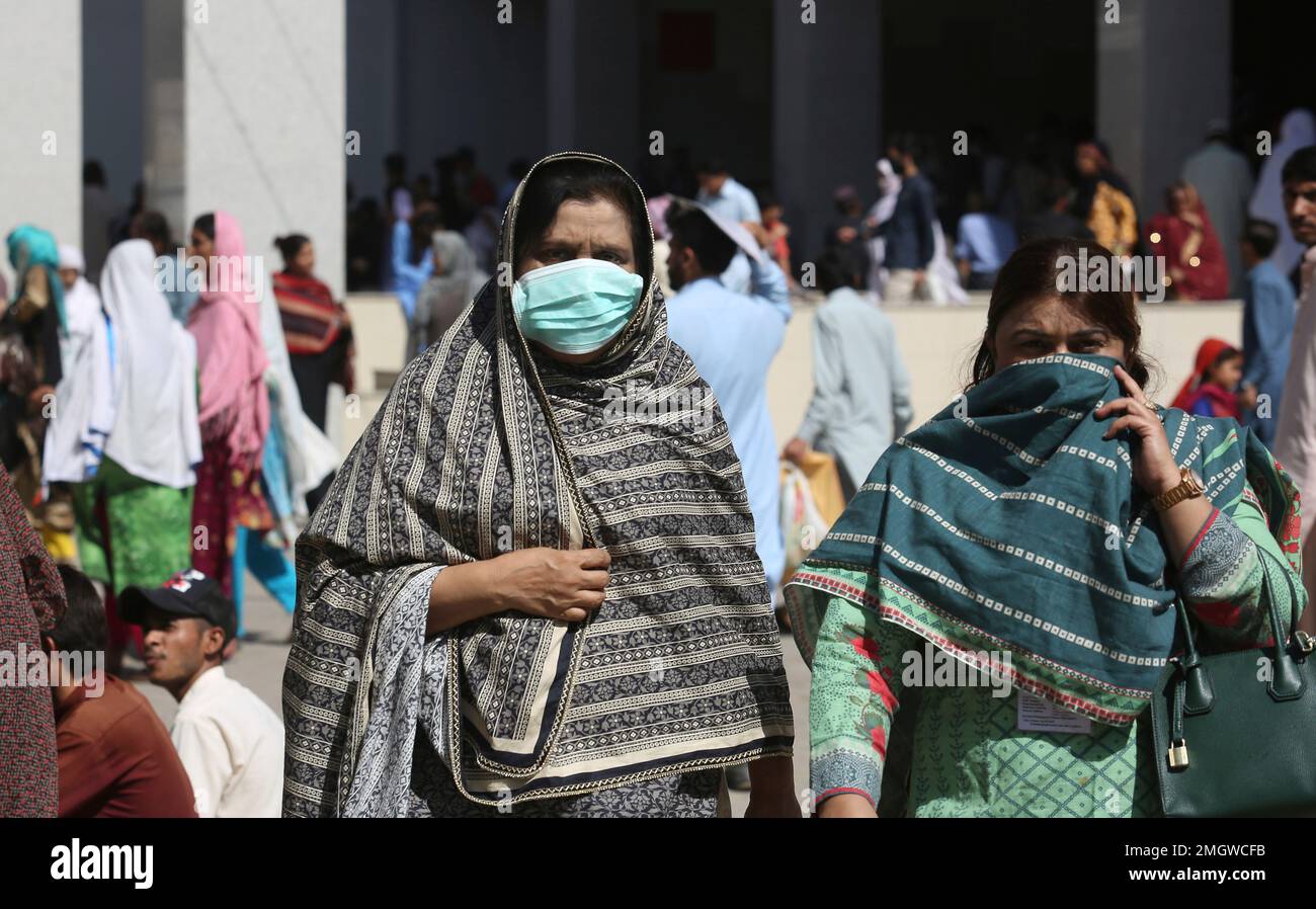 Pakistani women wearing face masks leave the Aga Khan hospital where a ...