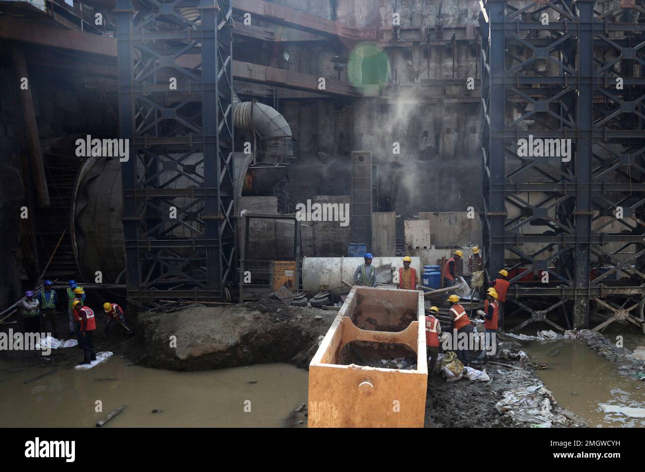 Indian laborers work at the site of the newly built underground Mumbai ...