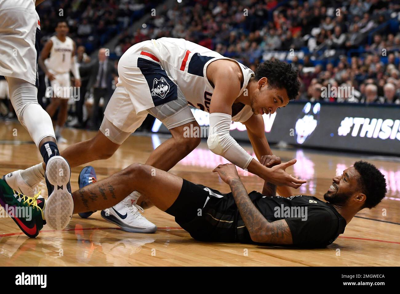Connecticut's James Bouknight helps Central Florida's Ceasar DeJesus ...