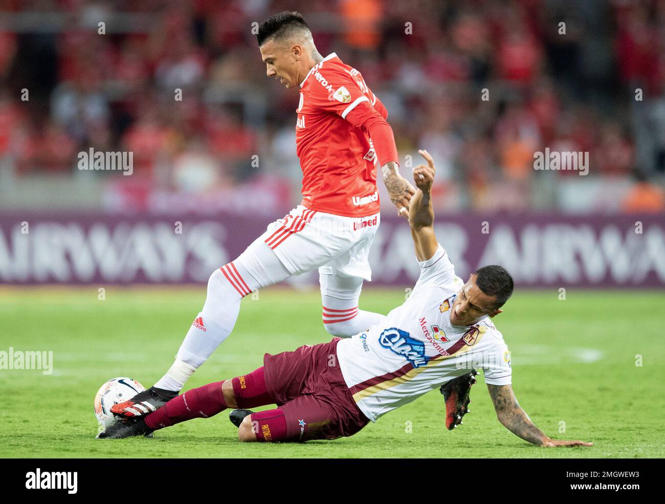 Victor Cuesta of Brazil's Internacional, top, fights for the ball with ...