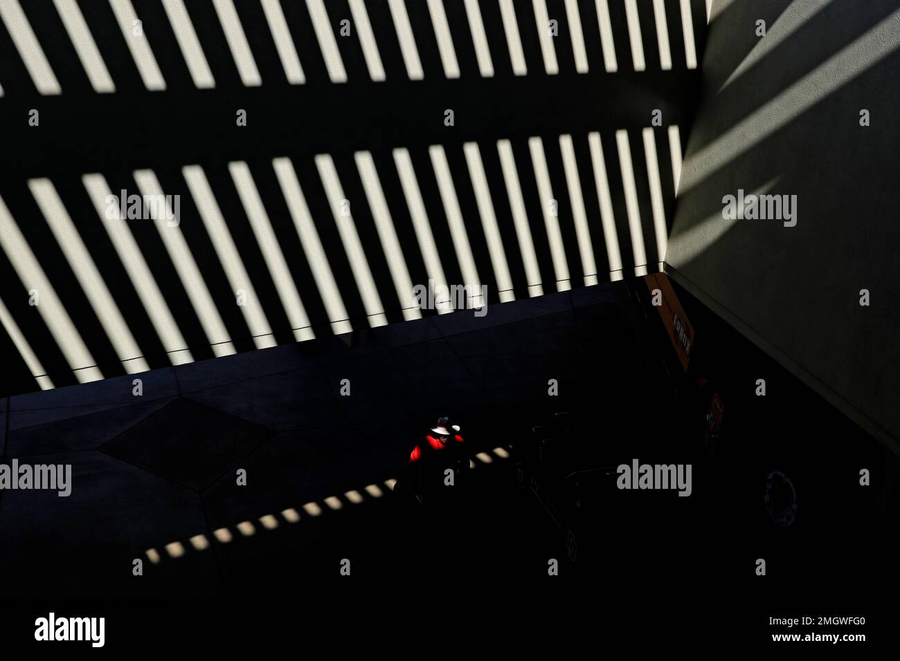 A fan walks along a concourse before a spring training baseball game ...