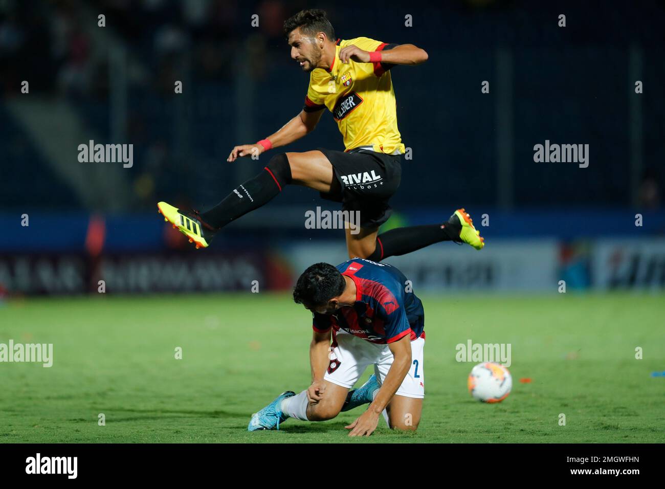 Bruno Pinatares of Ecuador's Barcelona jumps over Alberto Espinola of ...