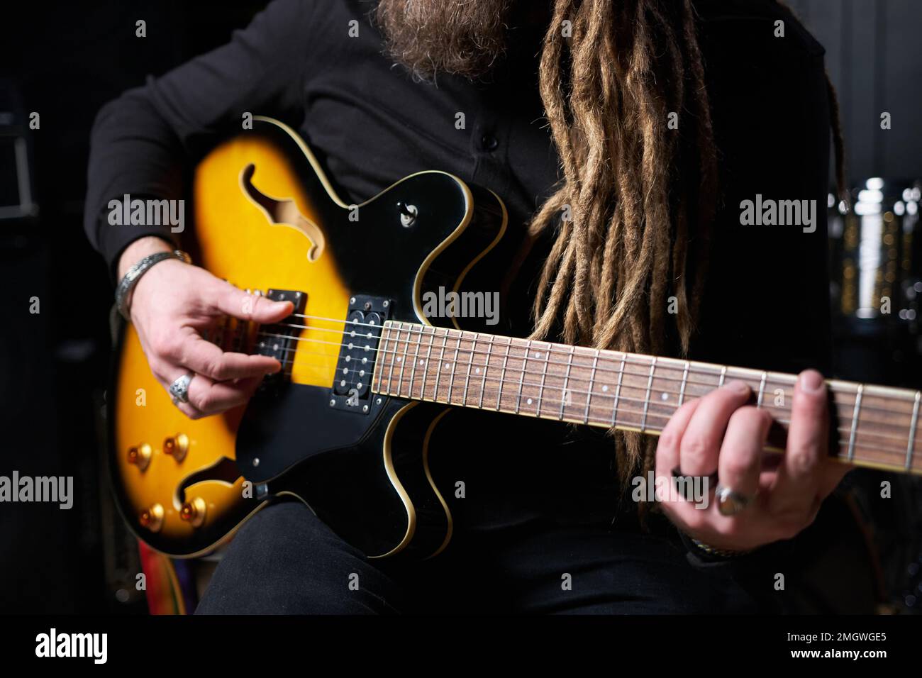 Guitarist man plays an electric guitar Close-up at studio Stock Photo ...