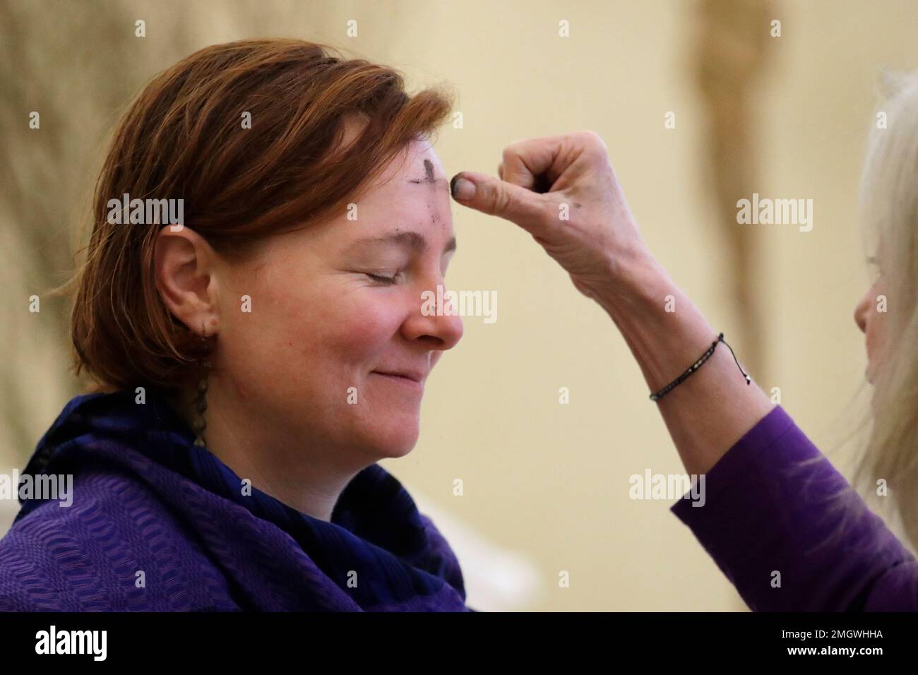 Anna Roach has ashes in the sign of a cross placed on her forehead by ...