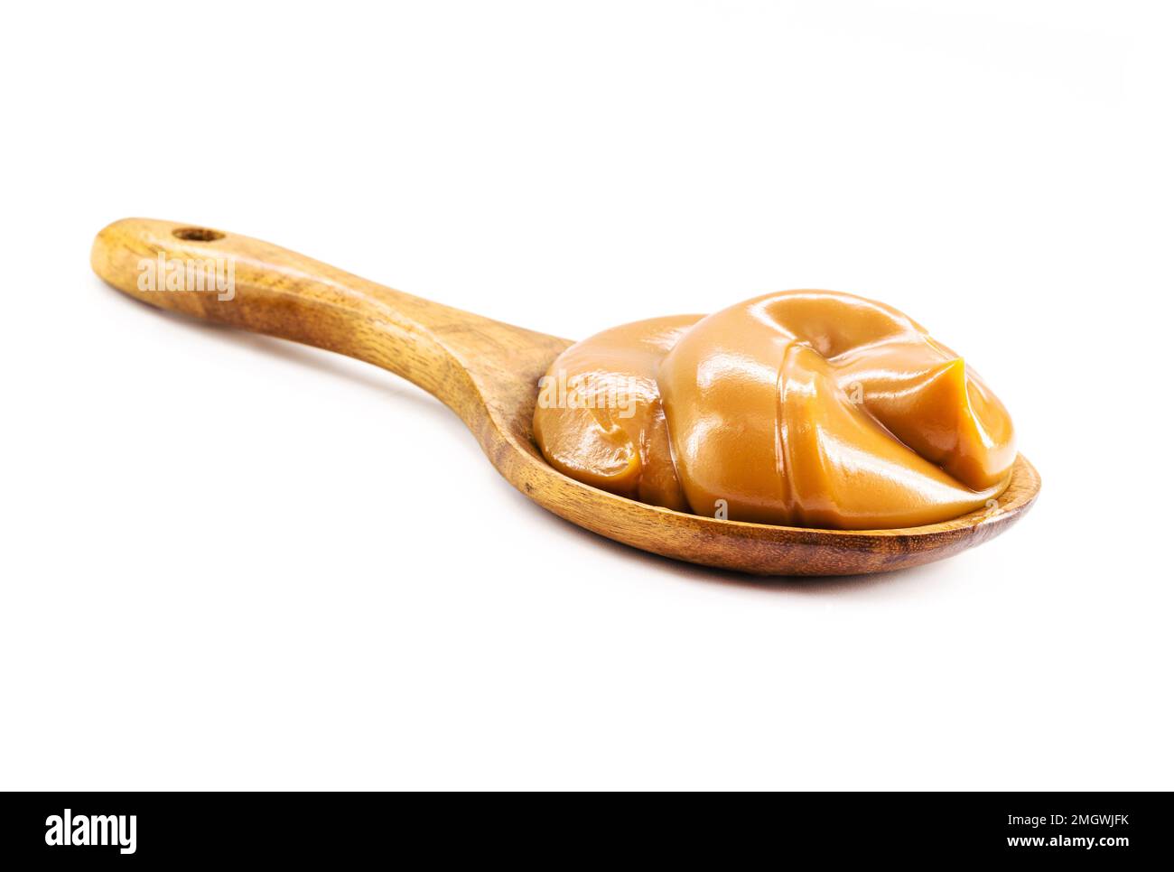 spoon with homemade dulce de leche, condensed cream or pasty caramel ...