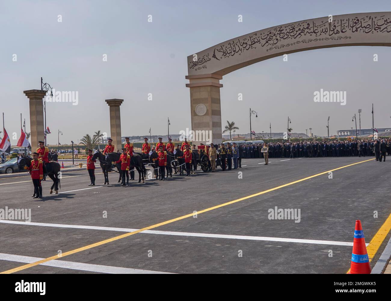 A horse-drawn carriage carries the flag-draped coffin of former ...