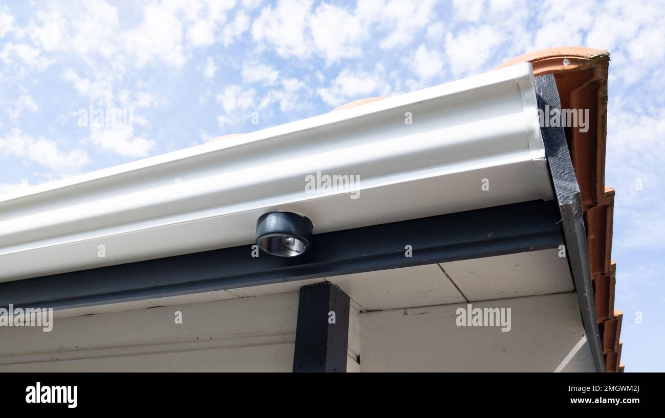 Gable and siding white frame gutter guard system on single family home ...