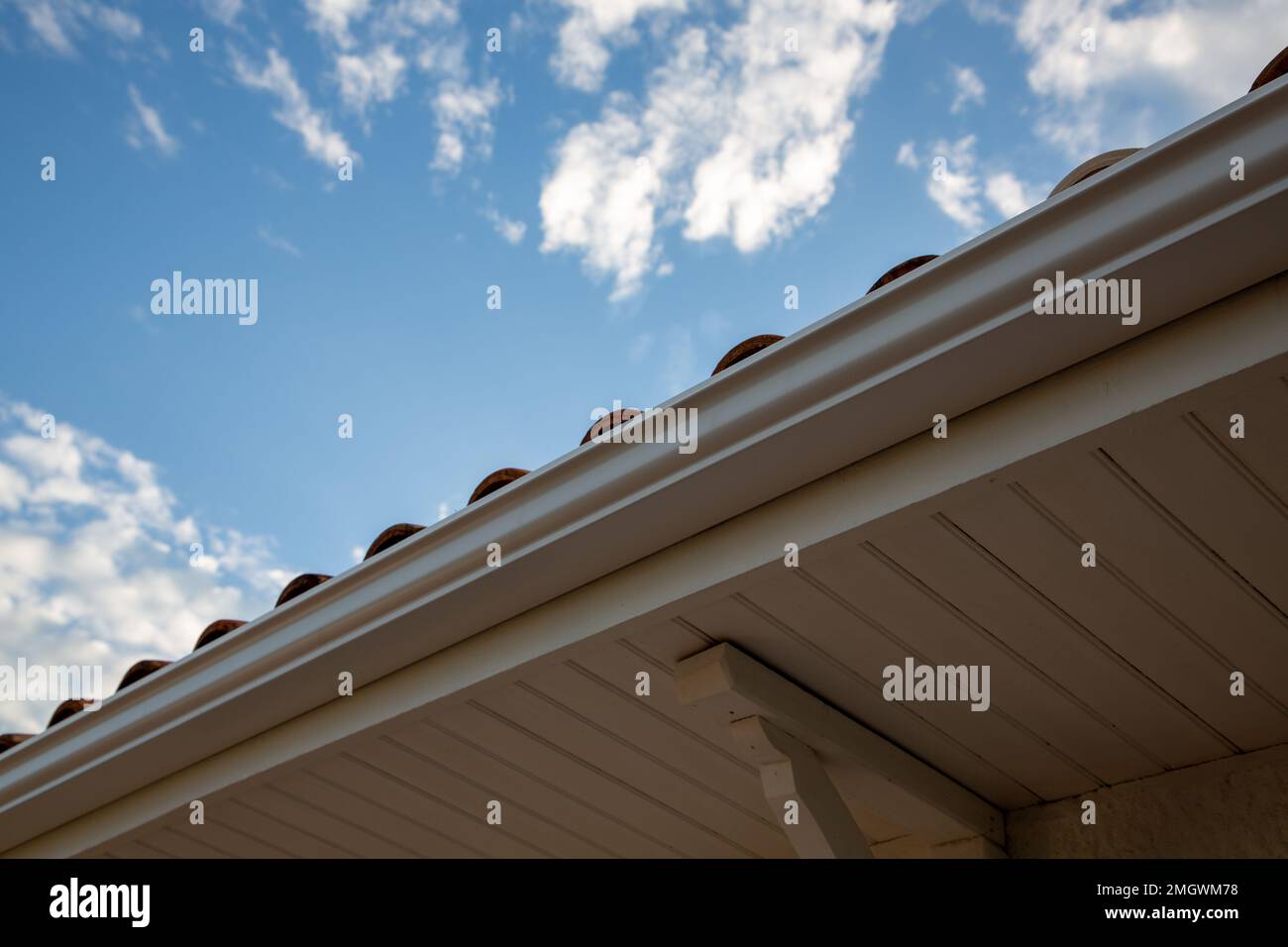 new modern house with gutter roof wall under blue cloud sky Stock Photo ...