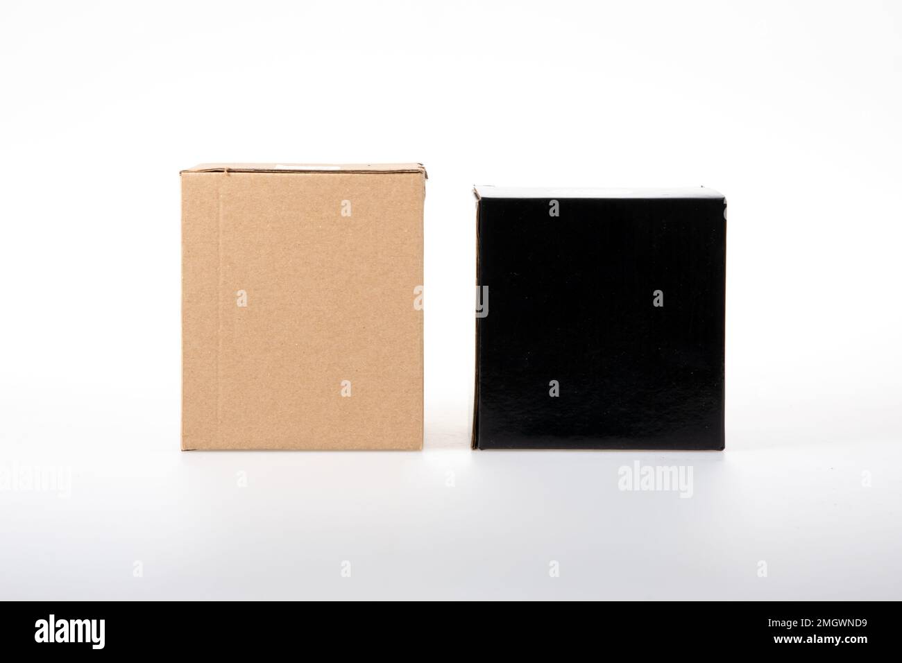 Group of two goods in cardboard boxes brown and black Stock Photo - Alamy