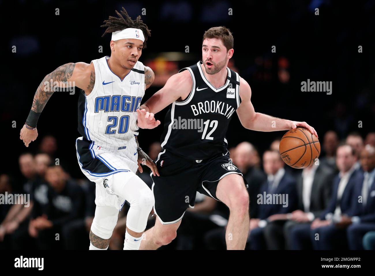 Brooklyn Nets forward Joe Harris (12) drives past Orlando Magic guard ...