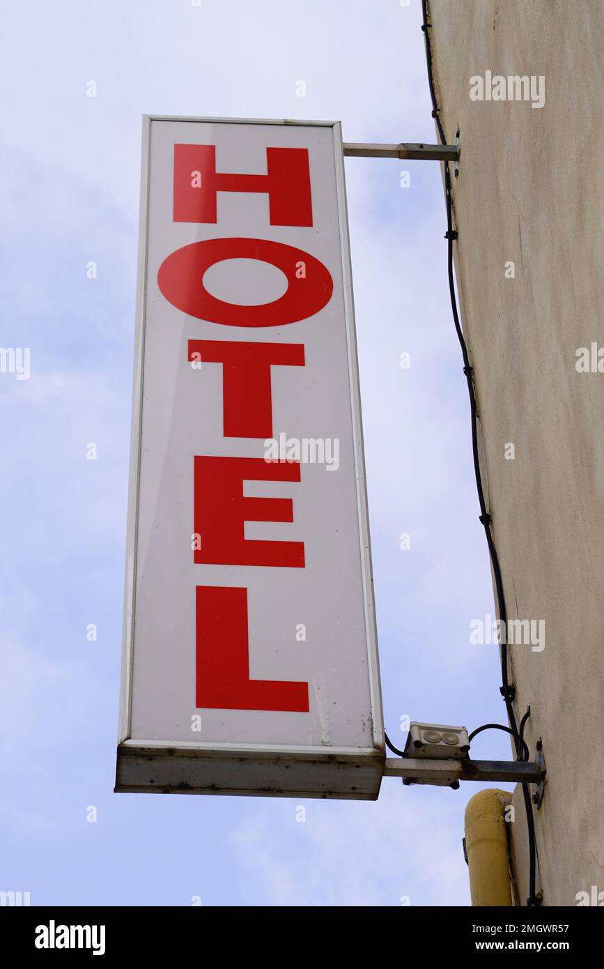 Hotel sign text red in wall city building facade in french tourist town ...
