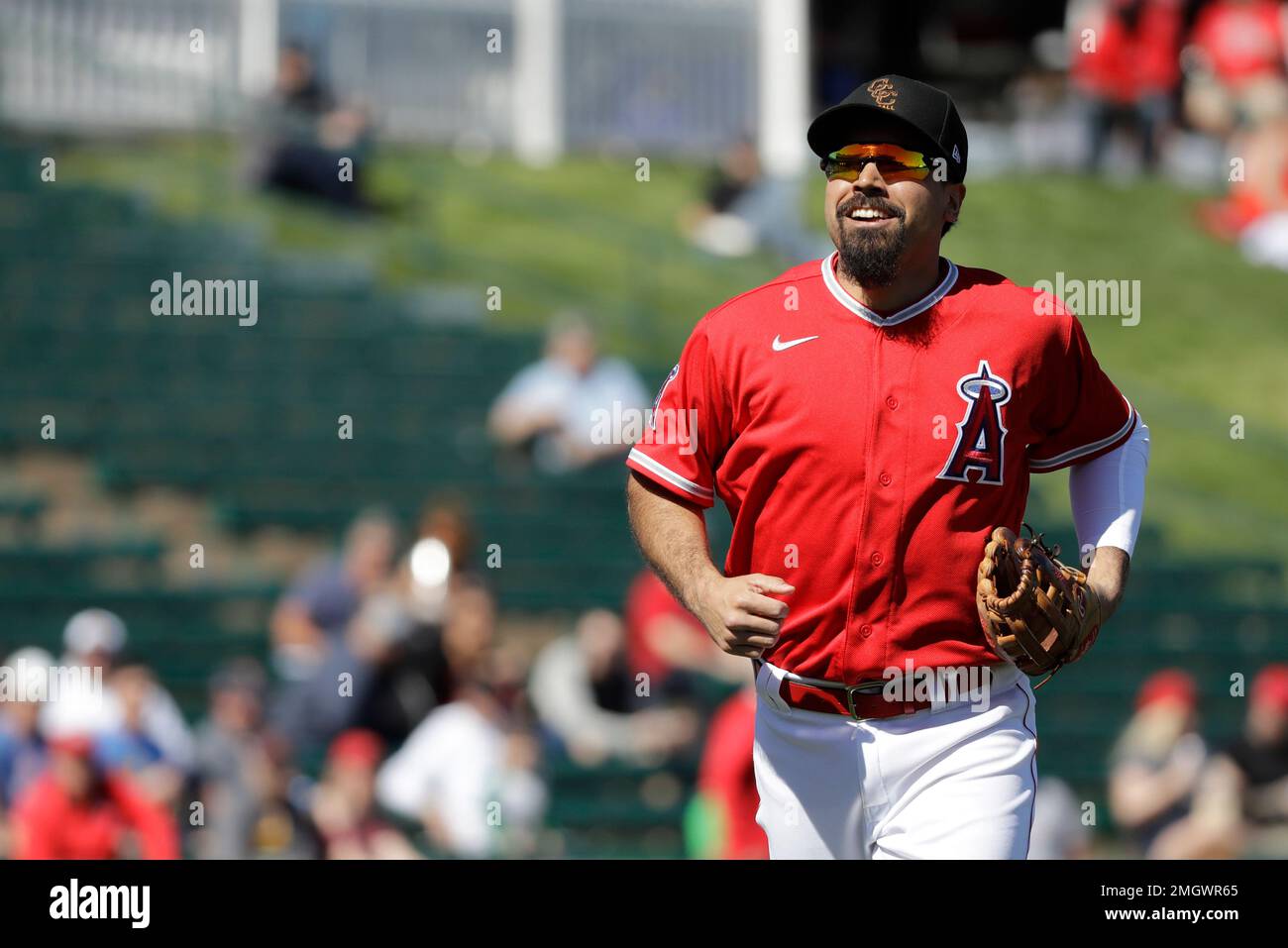 Los Angeles Angels' Anthony Rendon smiles as he runs to the dugout ...