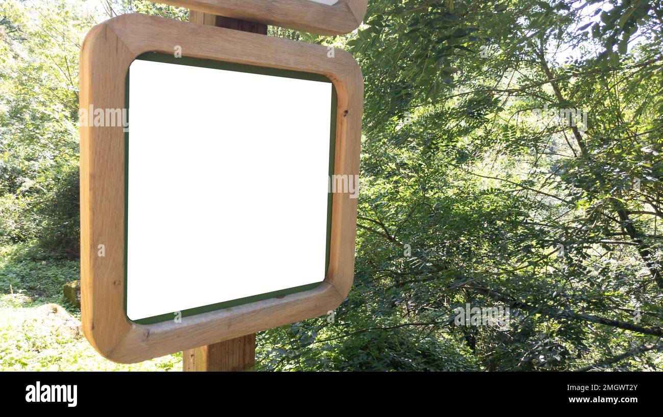 Empty white mockup information blank sign board in the park forest ...