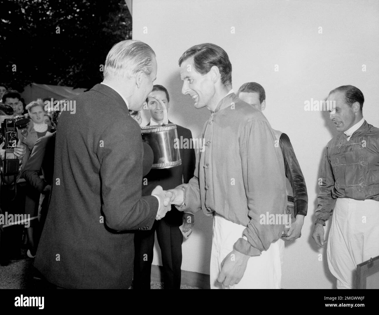 Group Captain Peter Townsend receives his prize from the track ...