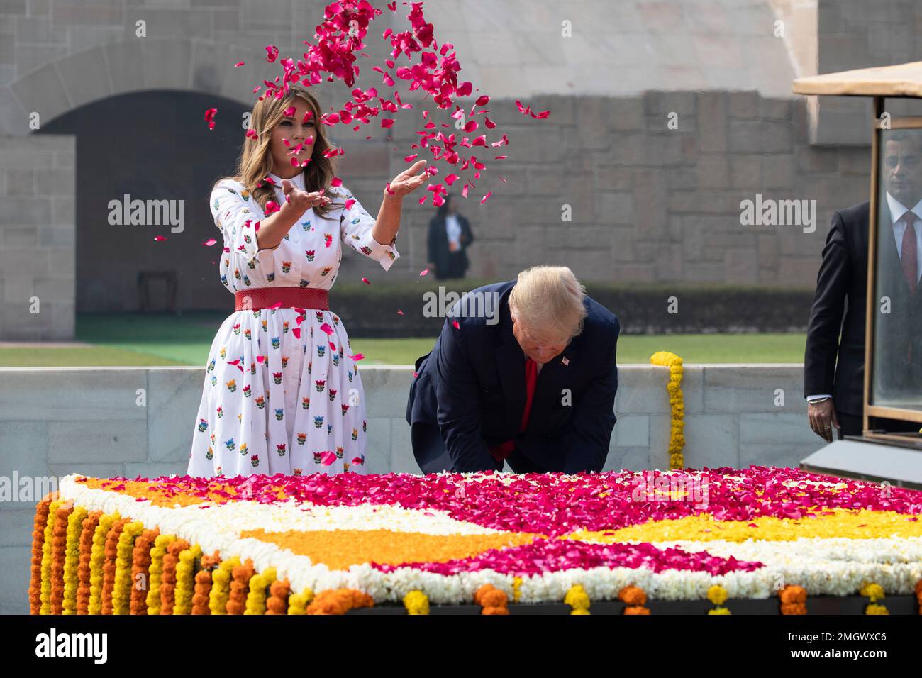 U.S. President Donald Trump and first lady Melania Trump offer floral ...