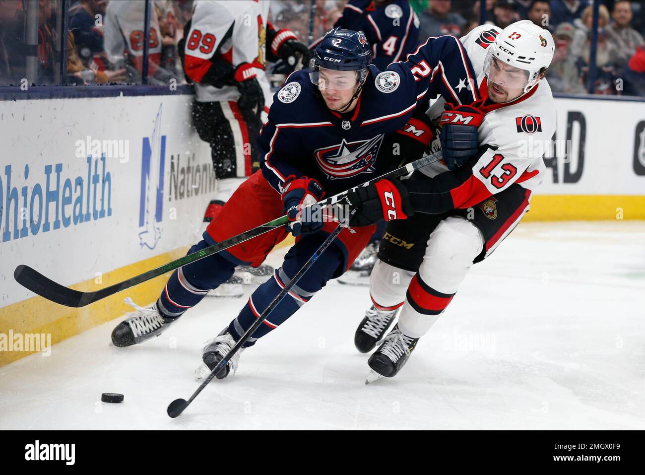 Columbus Blue Jackets' Andrew Peeke, left, and Ottawa Senators' Nick ...
