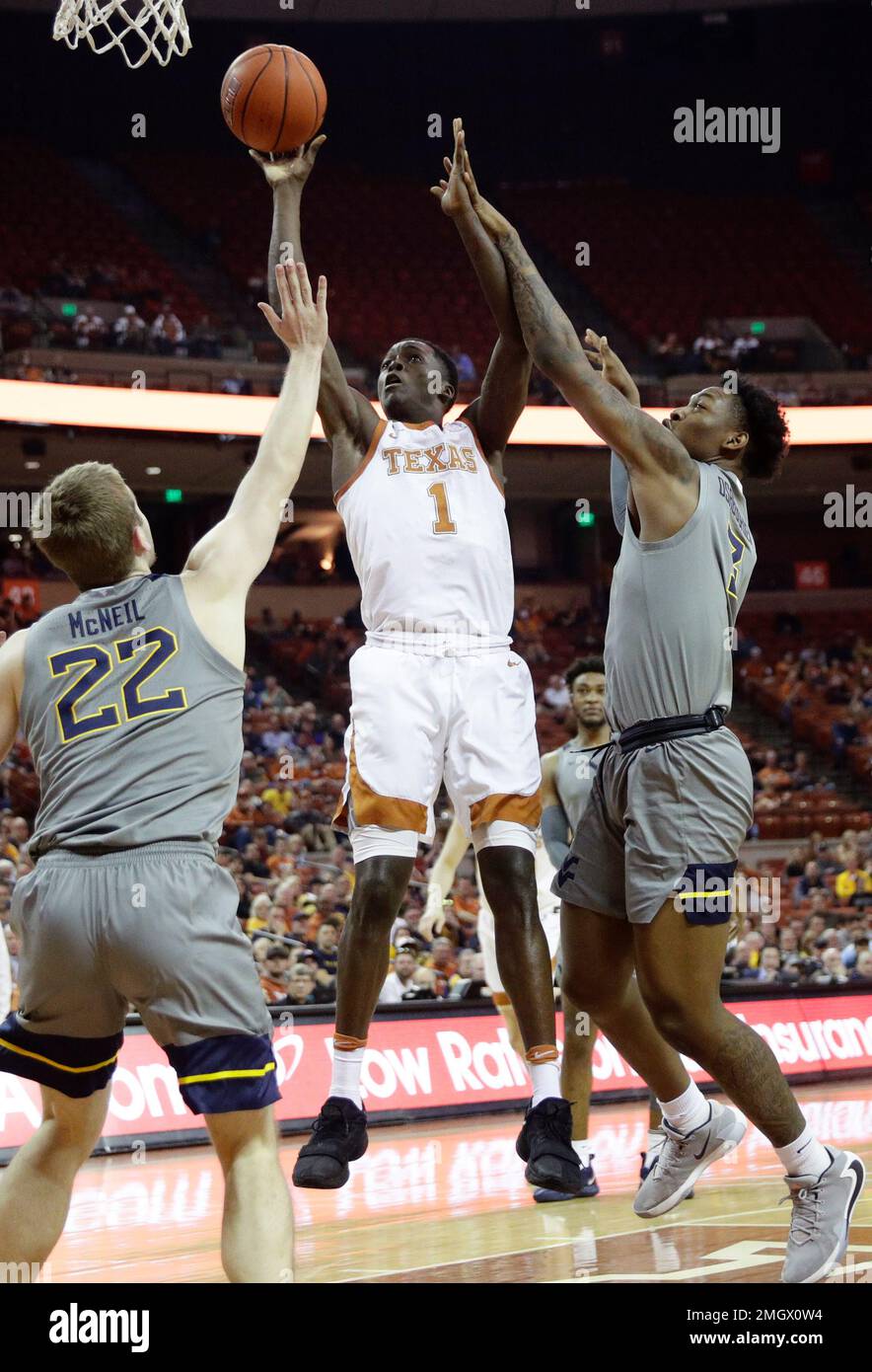 Texas guard Andrew Jones (1) shoots over West Virginia guard Sean ...