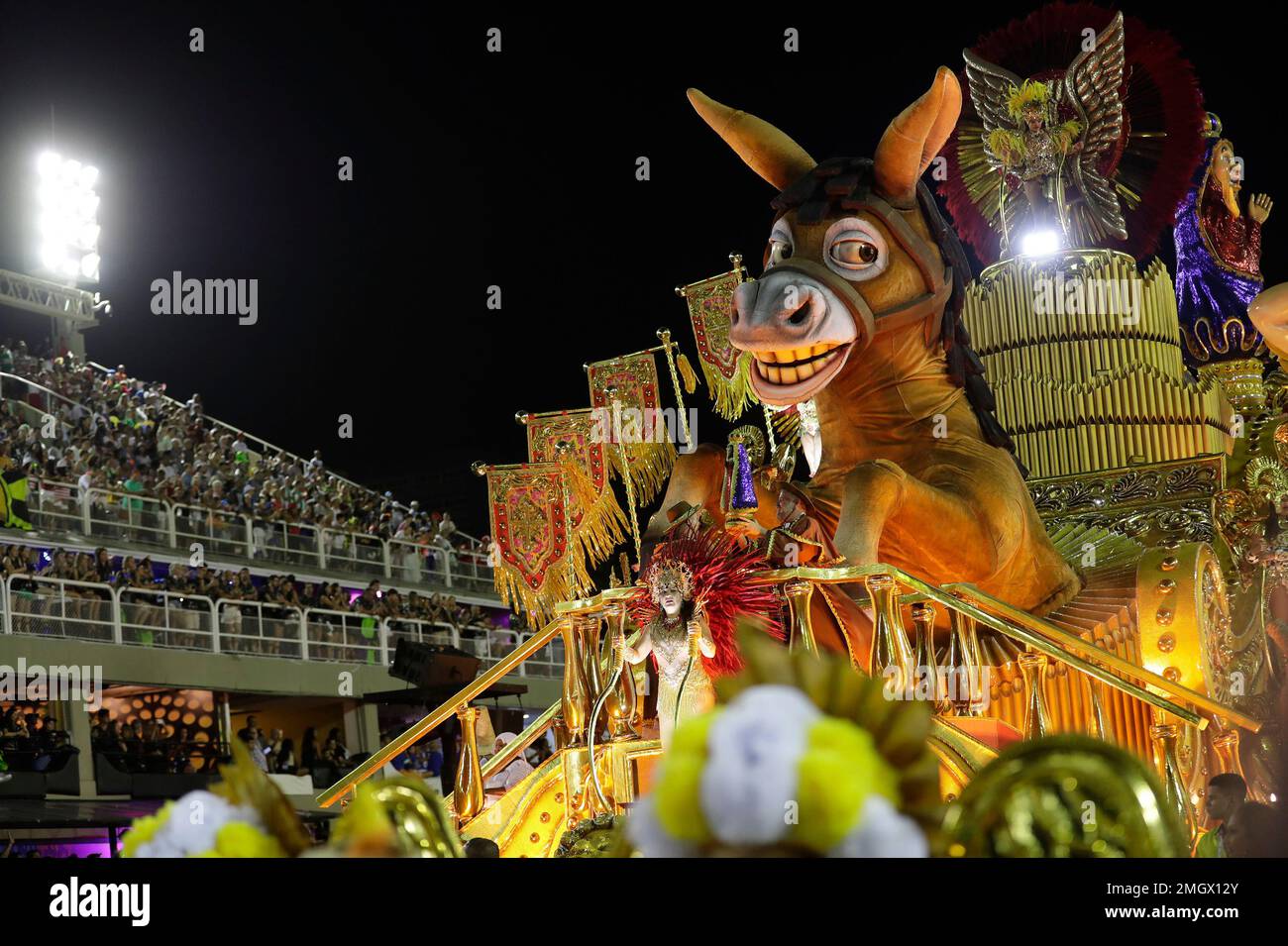 Performers from the Sao Clemente samba school parade on a float during ...