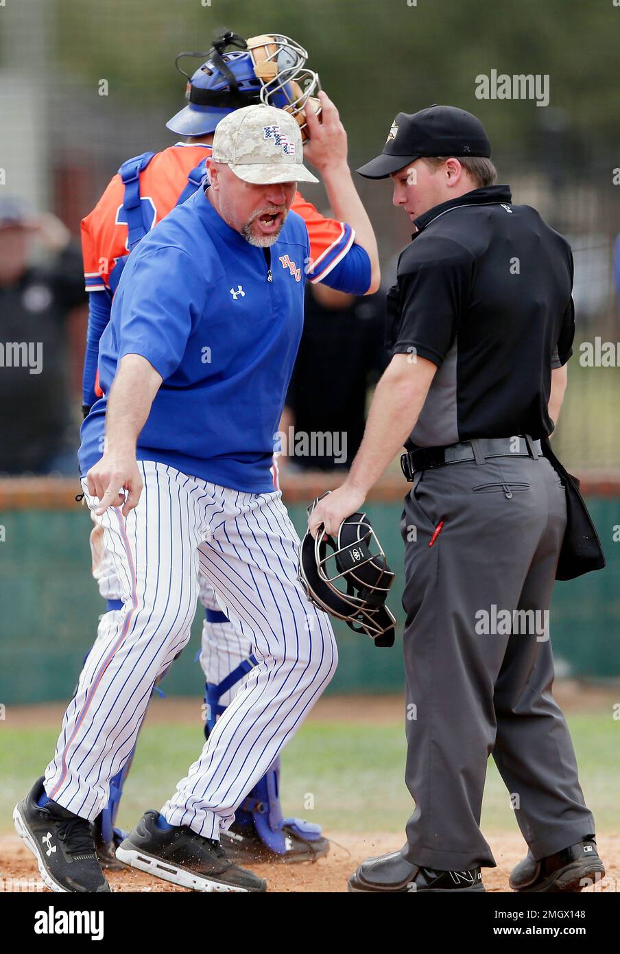 Houston Baptist head coach Jared Moon, left, argues a play at the plate ...