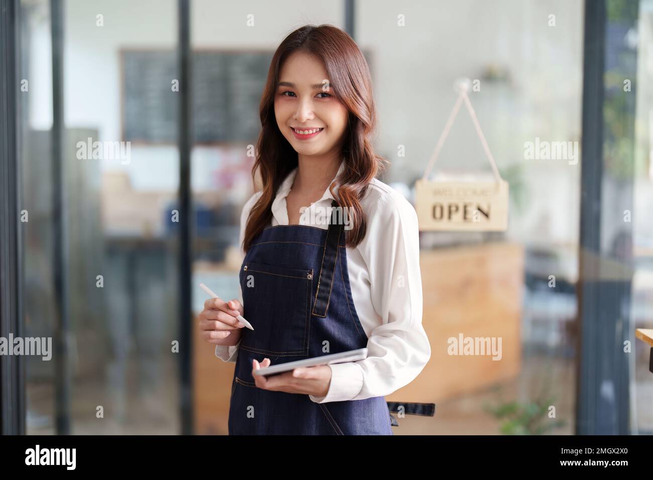 Beautiful female manager in restaurant with tablet. Man coffee shop ...