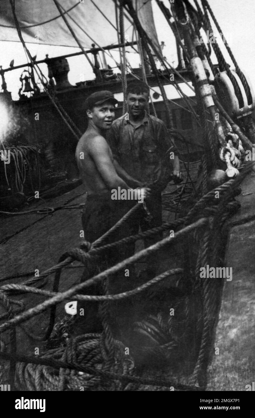 Two sailors standing on the deck of the four-masted steel barque ...