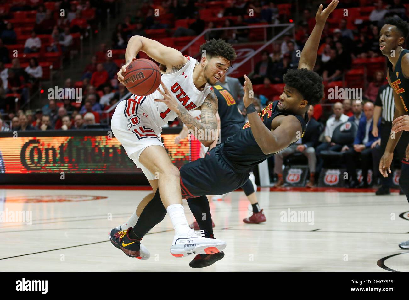 USC guard Ethan Anderson, right, falls as Utah forward Timmy Allen (1 ...