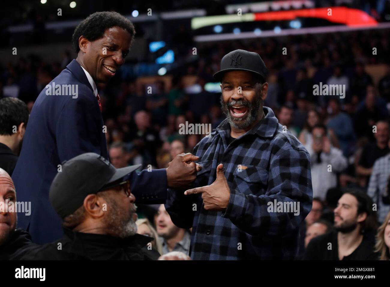 Actor Denzel Washington, right, jokes with former Los Angeles Lakers' A ...