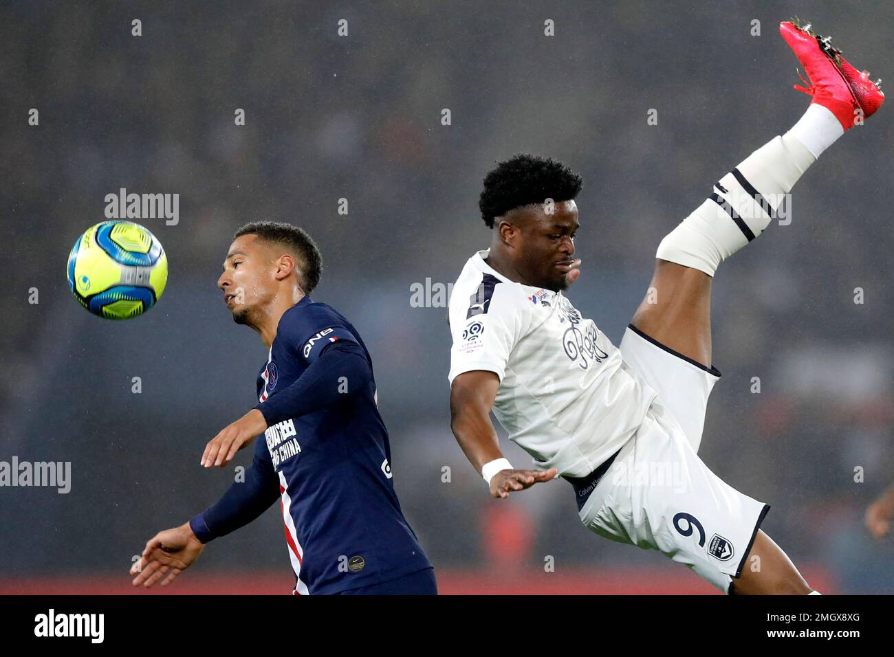 PSG's Thilo Kehrer, left, and Bordeaux's Josh Maja vie for the ball ...